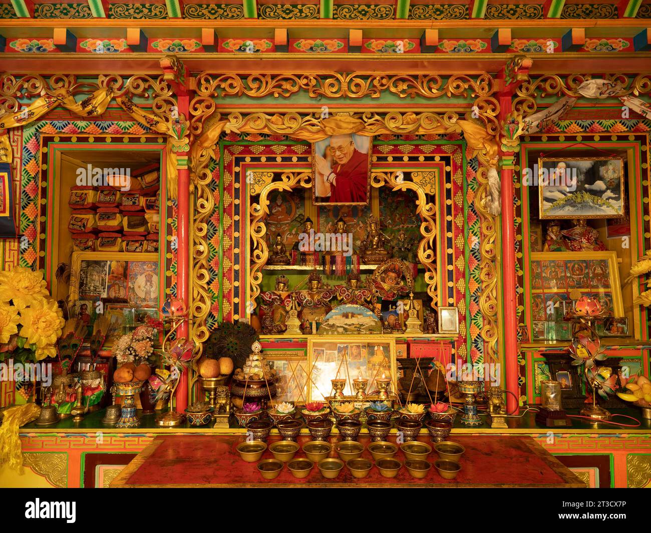 Tibetan prayer room with Dalai Llama image and wood carvings in Jiabe ...