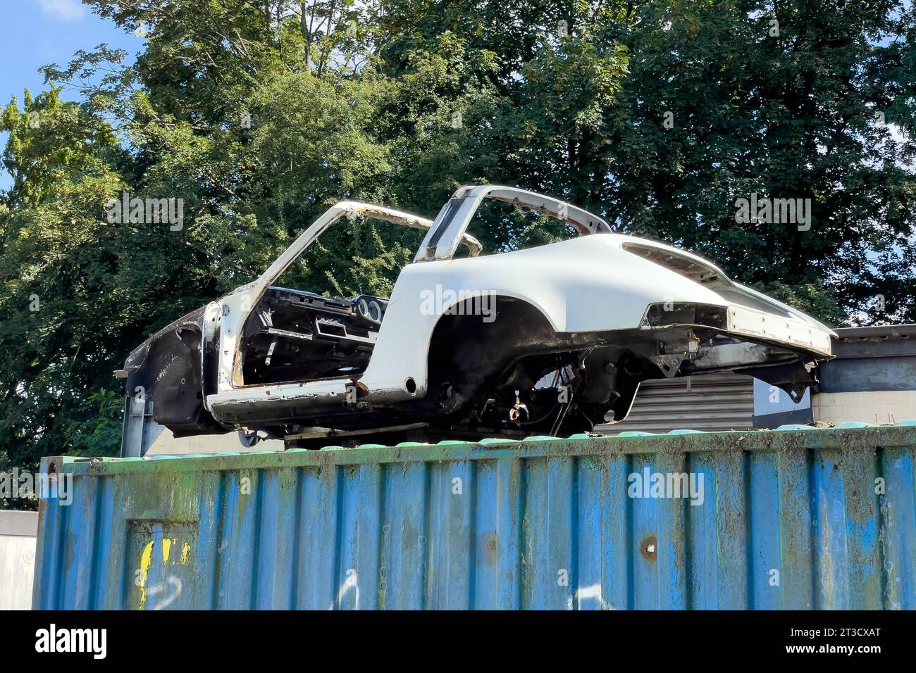 Old body of Porsche 911 Targa in colour white stands on container ...