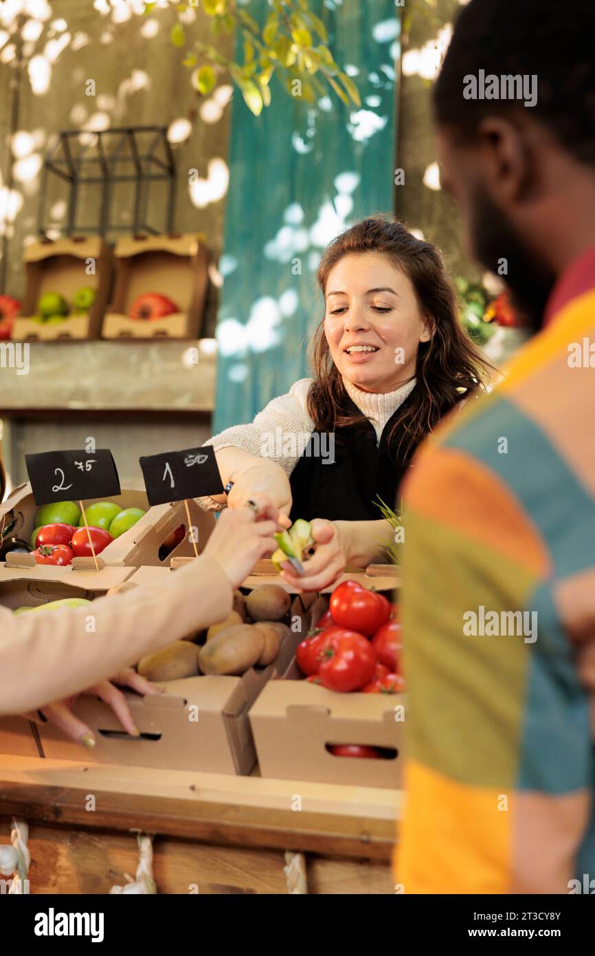 Smiling friendly organic fruits and vegetables shop owner offering ...