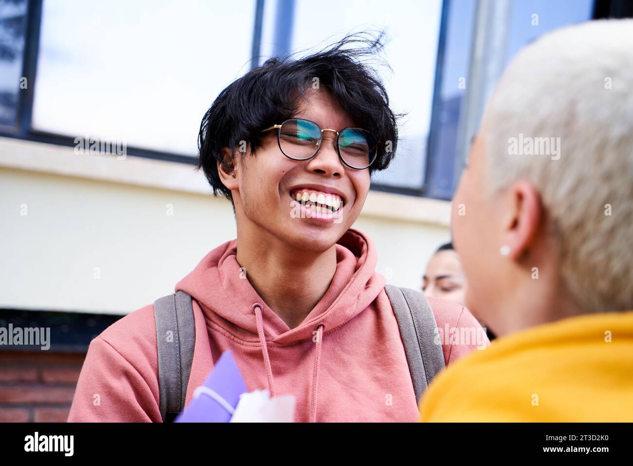 Group of two students laugh a lot and have fun outdoors. Teenage gen z ...