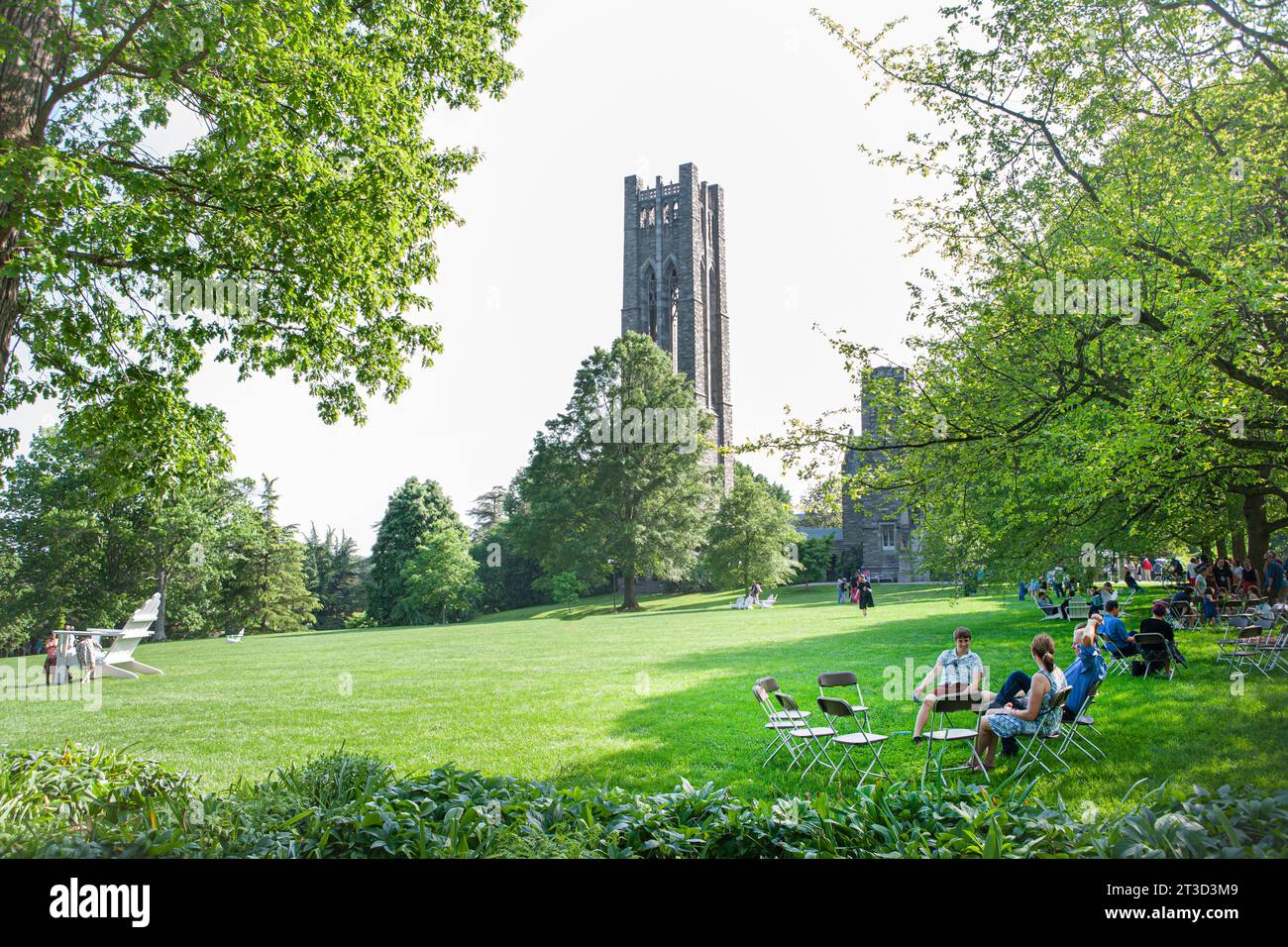 Students relaxing on campus lawn with Clothier Bell Tower in background ...