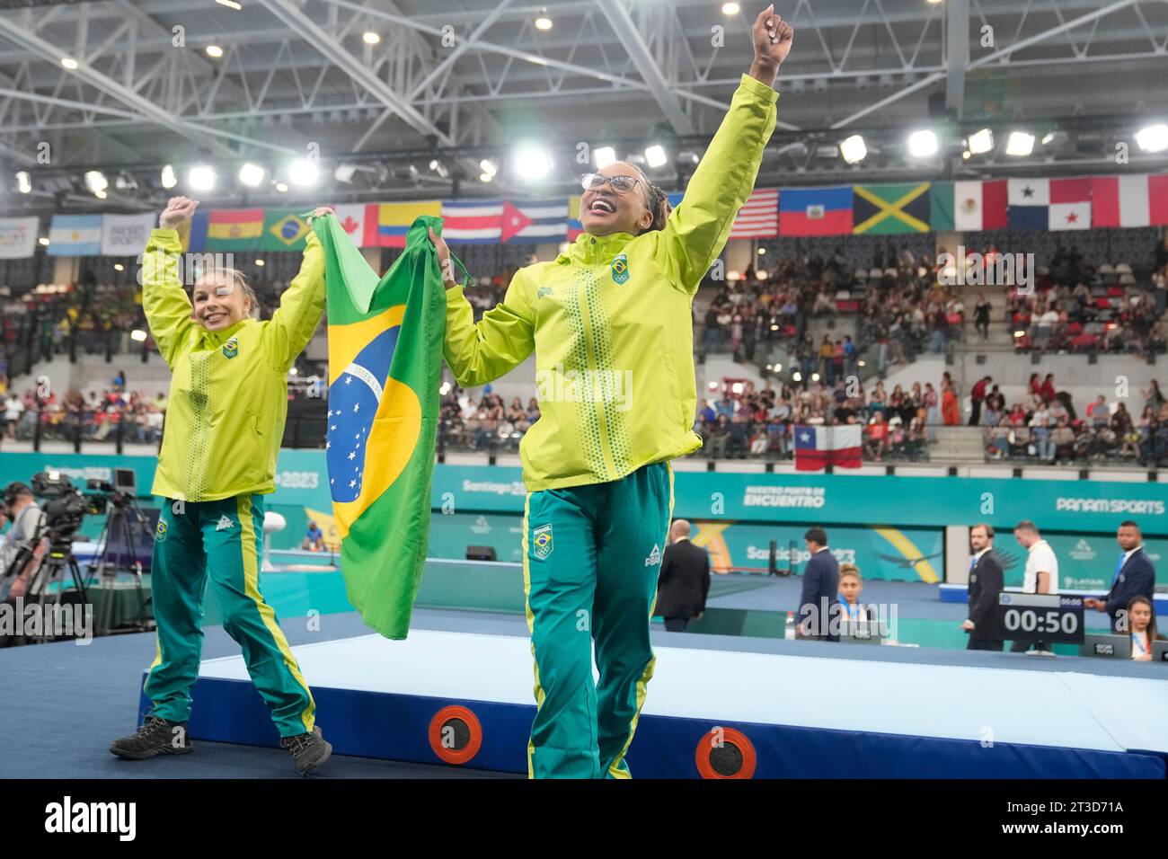 Brazil's Rebeca Andrade, right and Flavia Saravia hold their national ...
