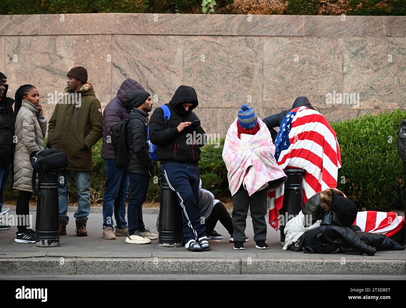 New York, New York, USA. 24th Oct, 2023. Migrants line up for ...