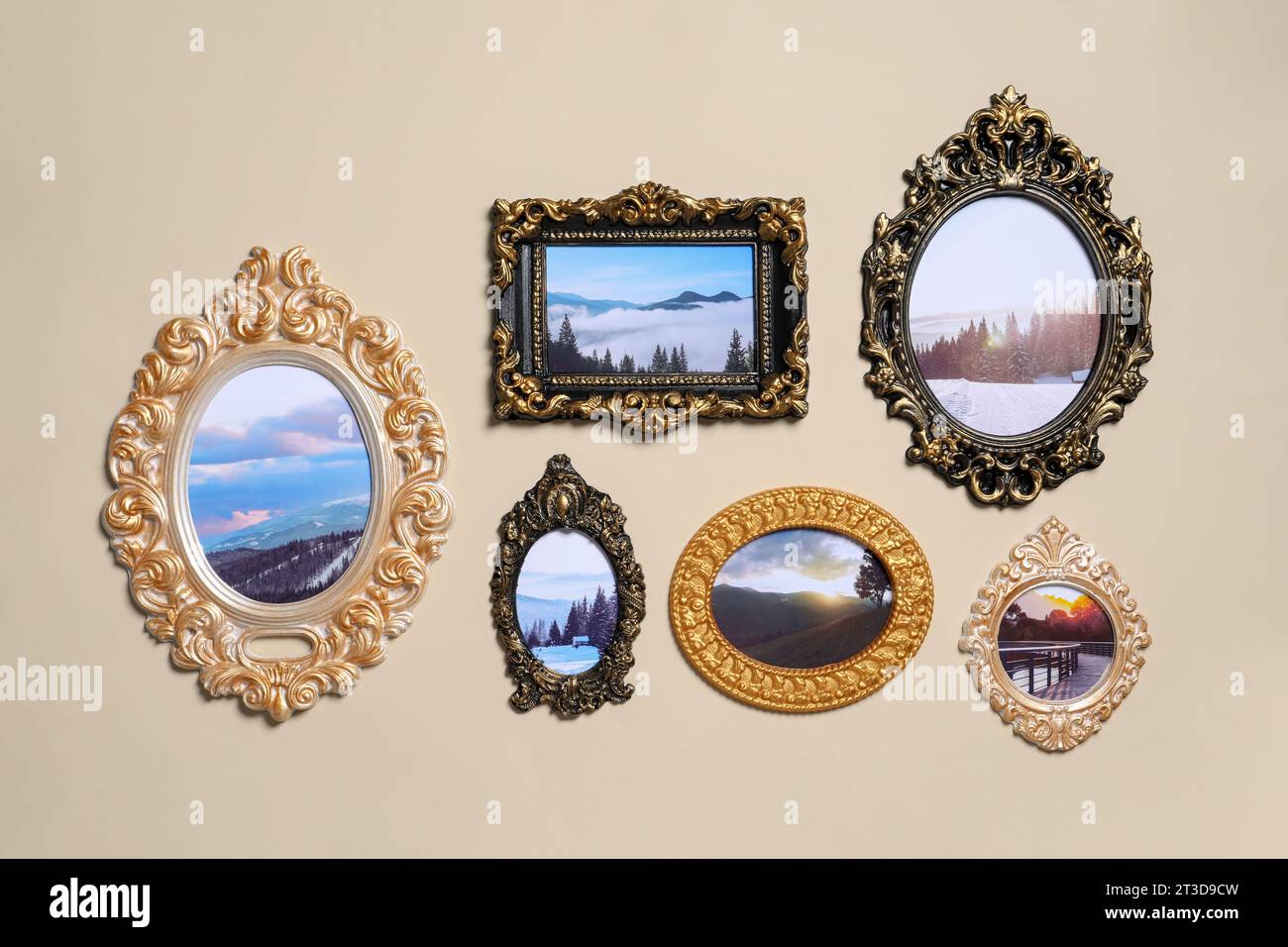 Vintage frames with photos of beautiful landscapes hanging on beige ...
