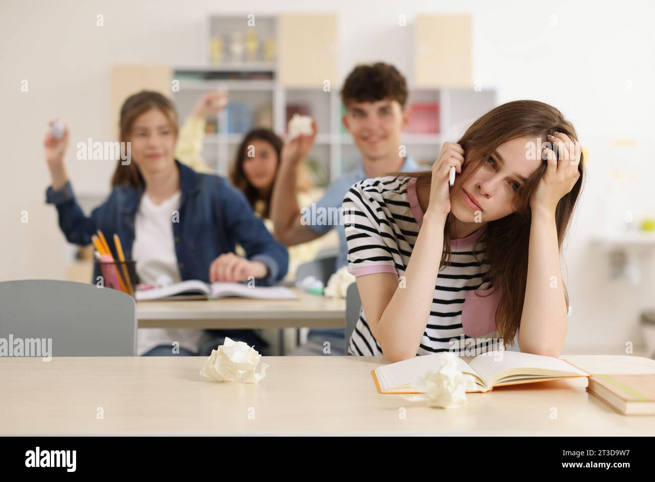 Teen problems. Students bullying their classmate in classroom ...