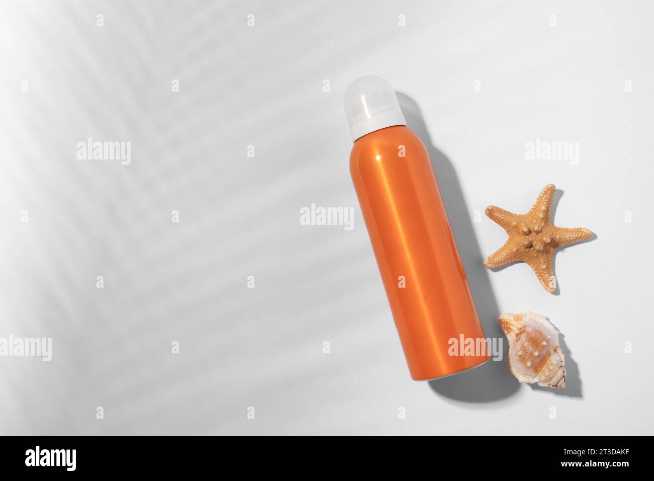 Sunscreen, starfish and seashell on white background, flat lay and ...