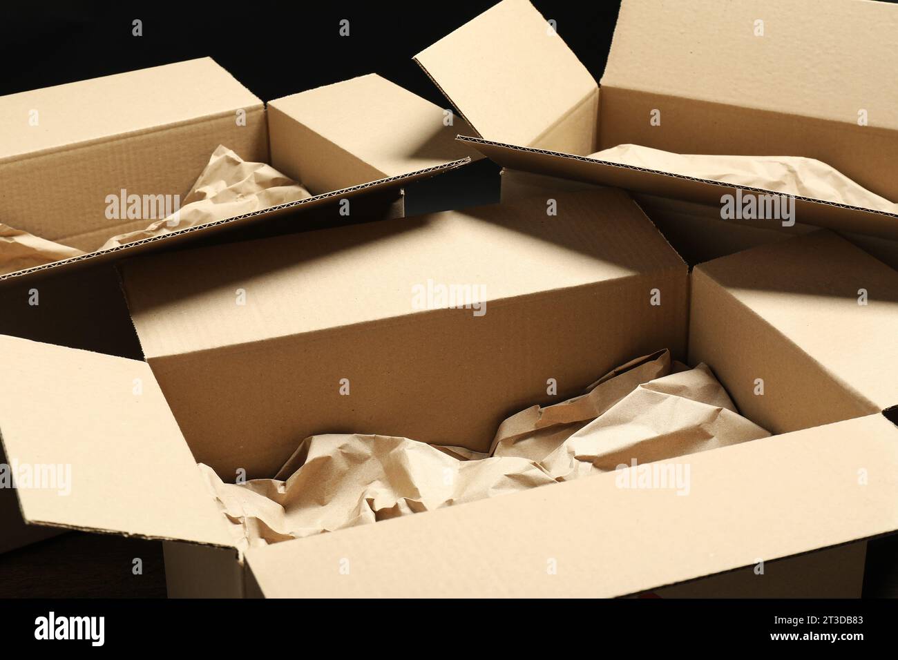 Open cardboard boxes with crumpled paper. Packaging goods Stock Photo ...