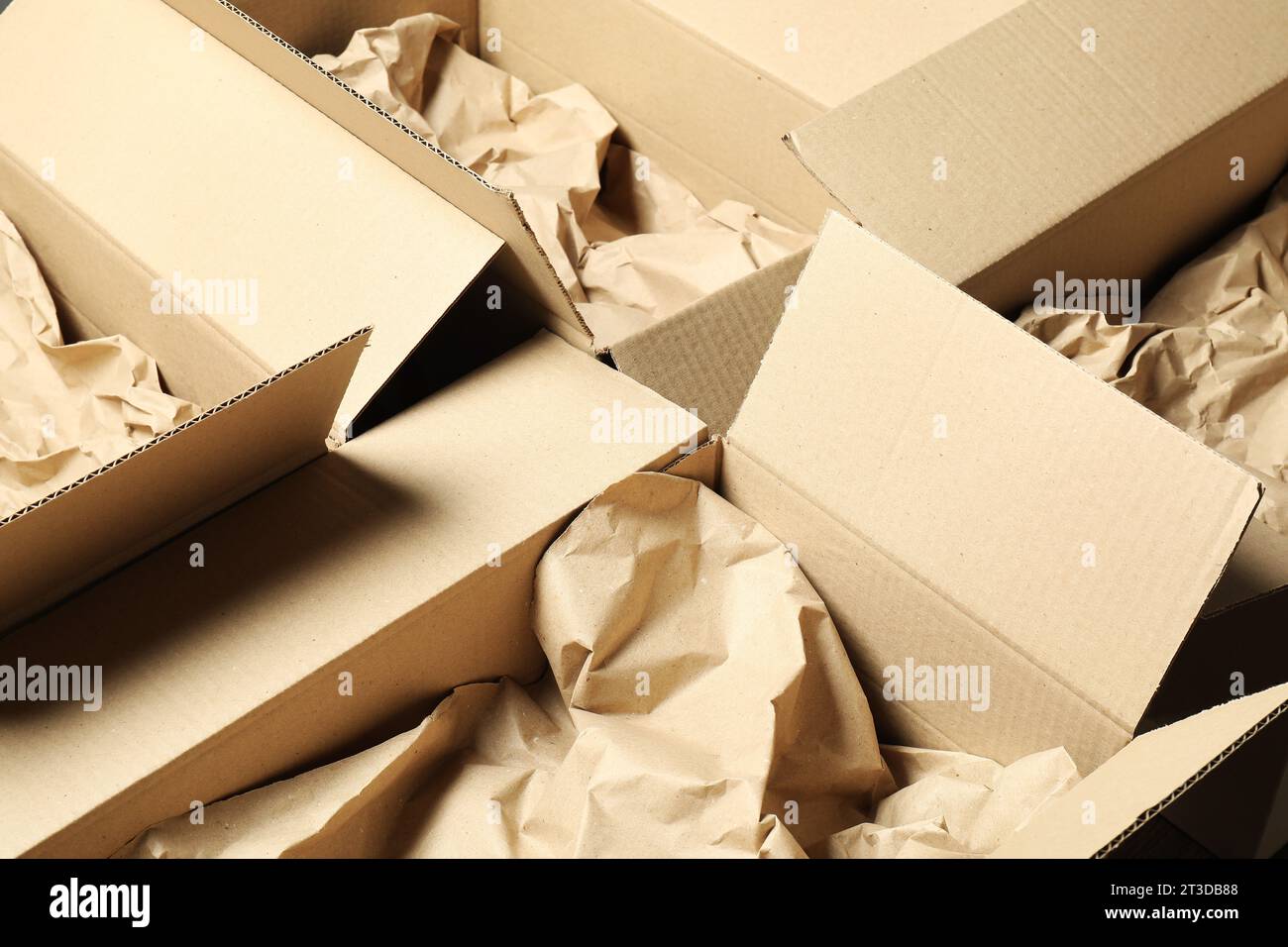 Open cardboard boxes with crumpled paper. Packaging goods Stock Photo ...