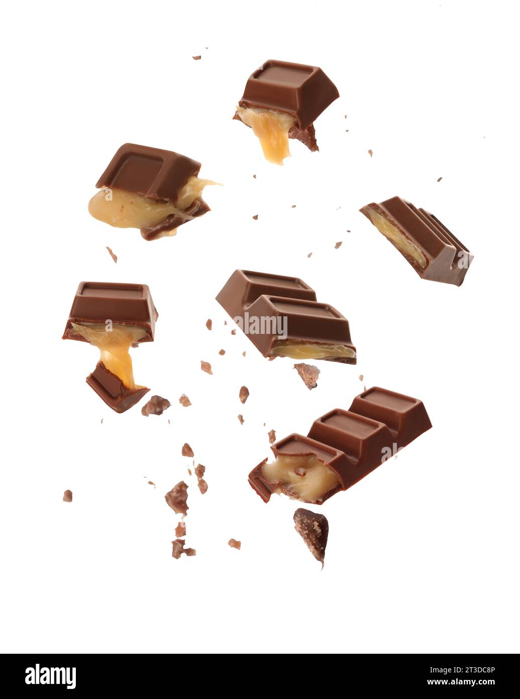 Pieces of delicious chocolate bars with caramel falling on white ...