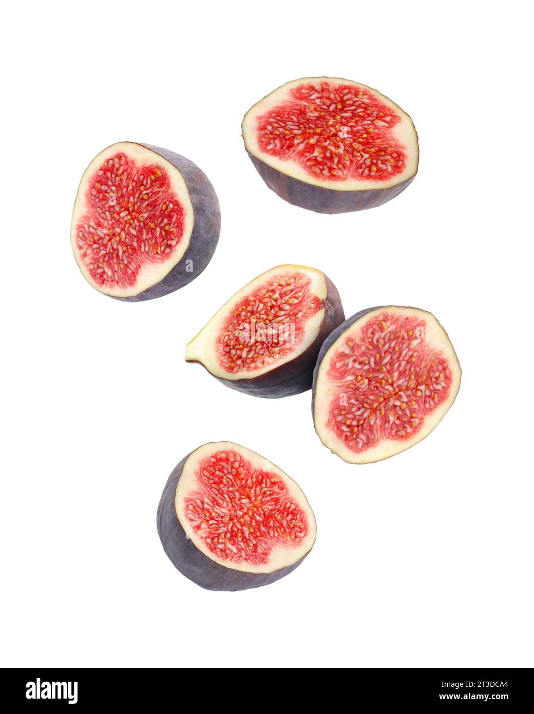 Halved fresh figs falling on white background Stock Photo - Alamy