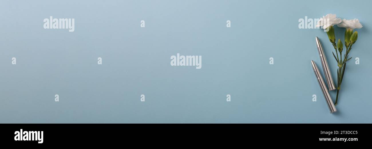Bullets and beautiful flowers on light blue background, flat lay ...
