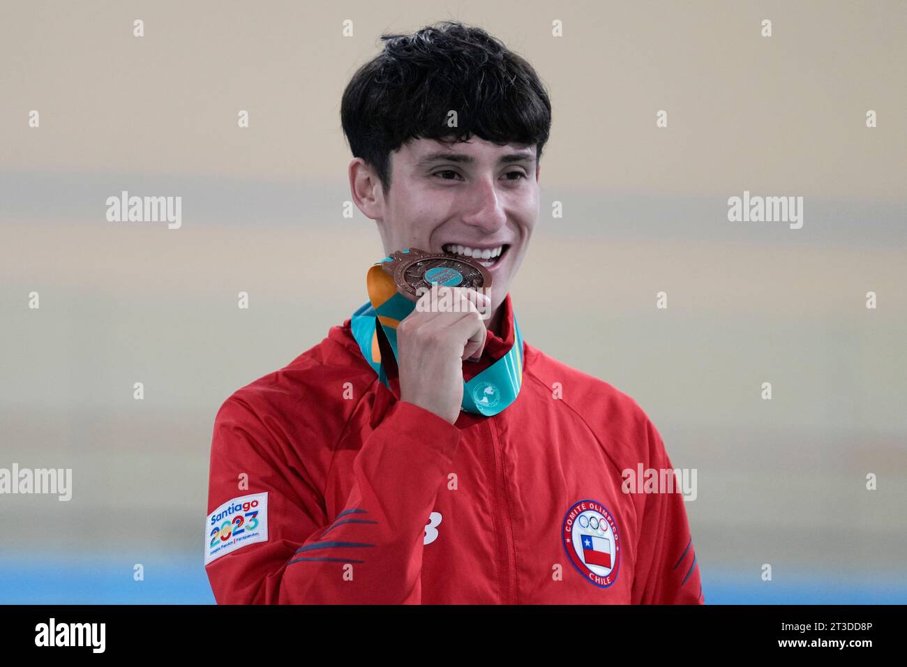 Chile's Jacob Decar bites his bronze medal during the award ceremony ...