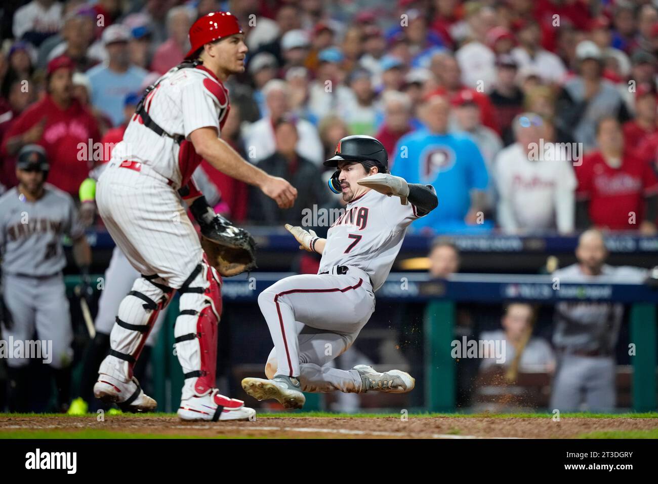 Arizona Diamondbacks' Corbin Carroll scores past Philadelphia Phillies catcher J.T. Realmuto on ...