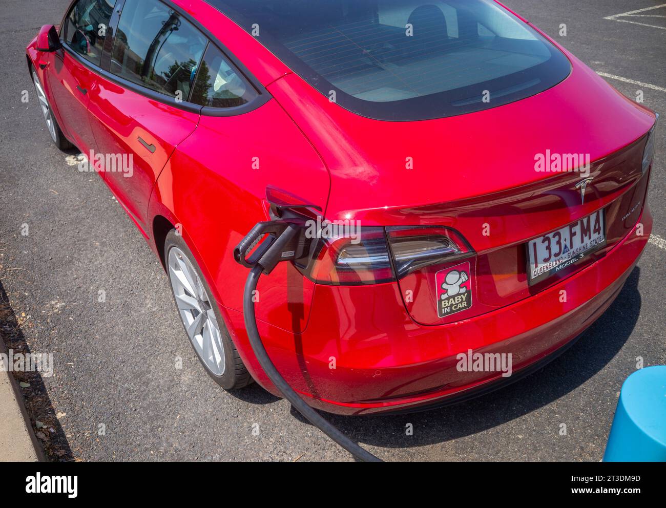 Red Tesla charging at the NRMA ev charger behind the town hall in Glen ...