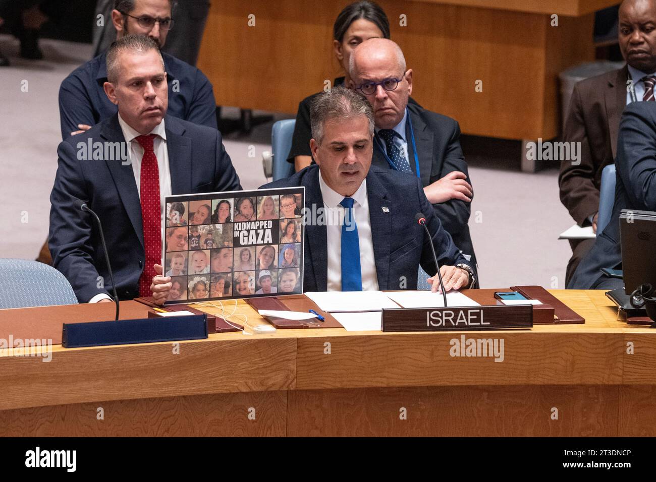 Foreign Minister of Israel Eli Cohen speaks while holding photos of ...