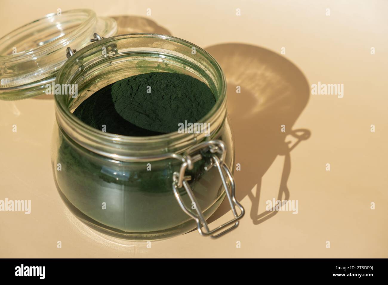 Organic blue-green algae spirulina powder food in glass jar. Health ...