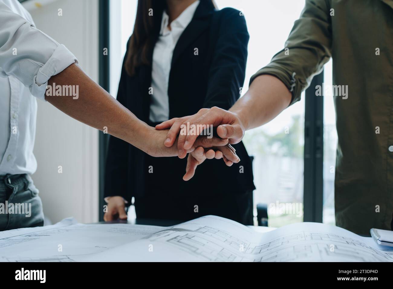 Engineers, designers and interior designers are together hands deal ...