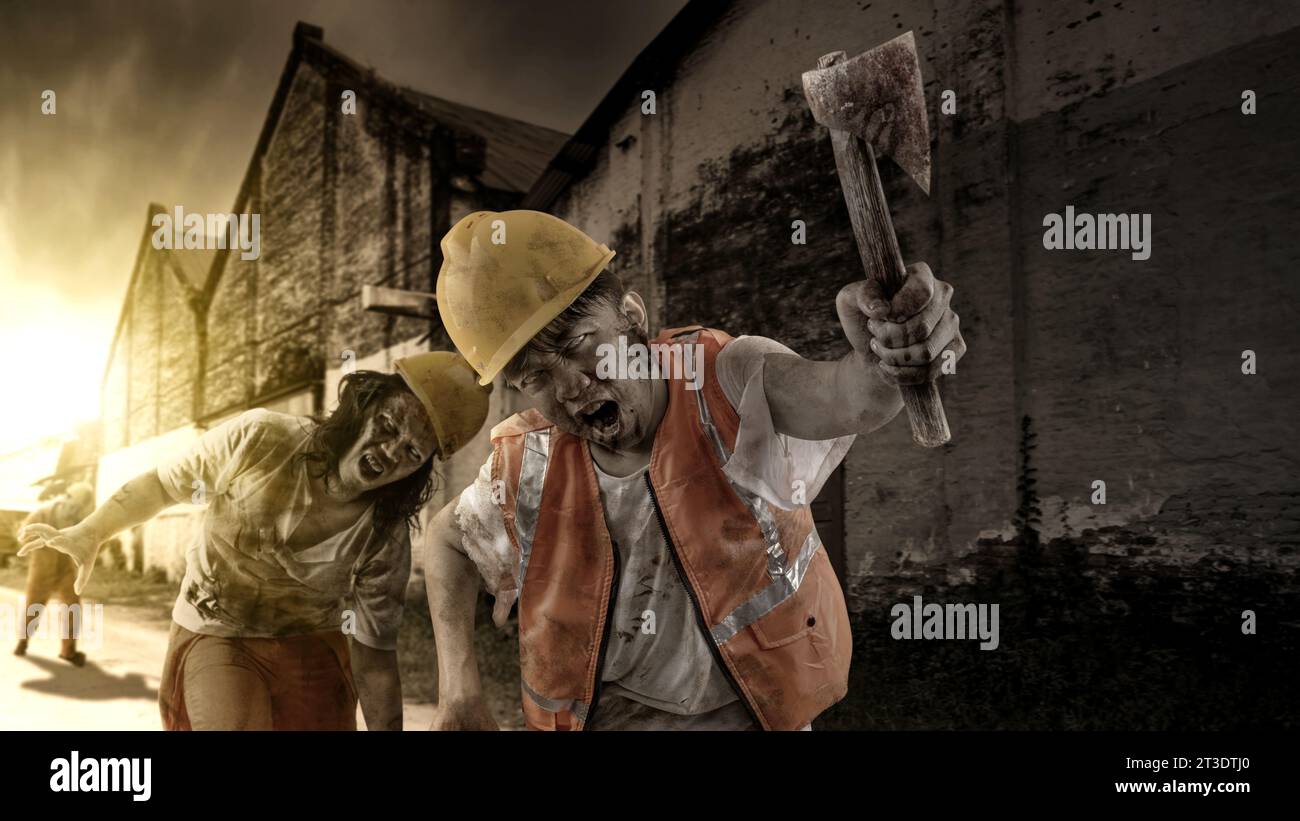 A scary construction worker zombie with blood and wounds on his body is ...