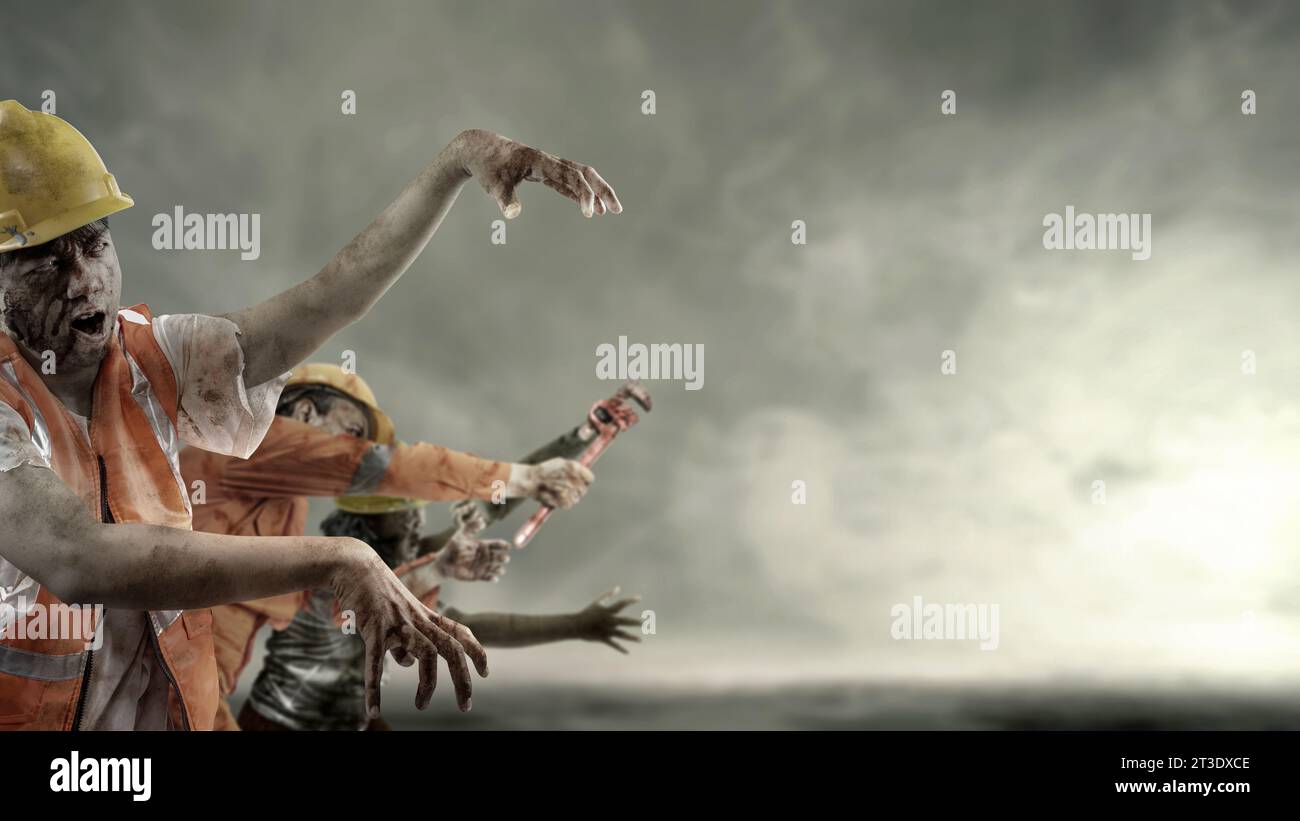 A scary construction worker zombie with blood and wounds on his body is ...