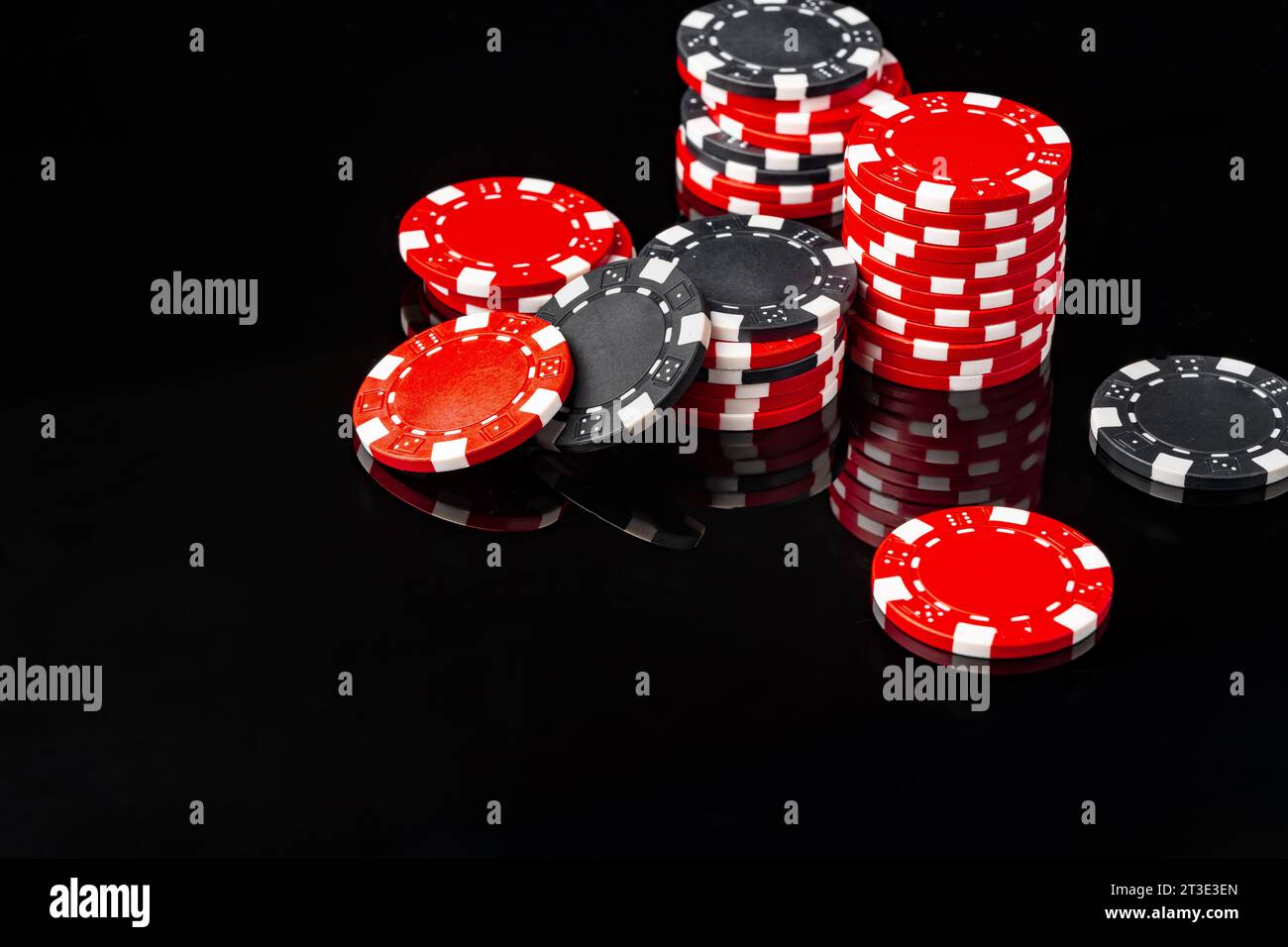 Red and black poker chips on black background Stock Photo - Alamy