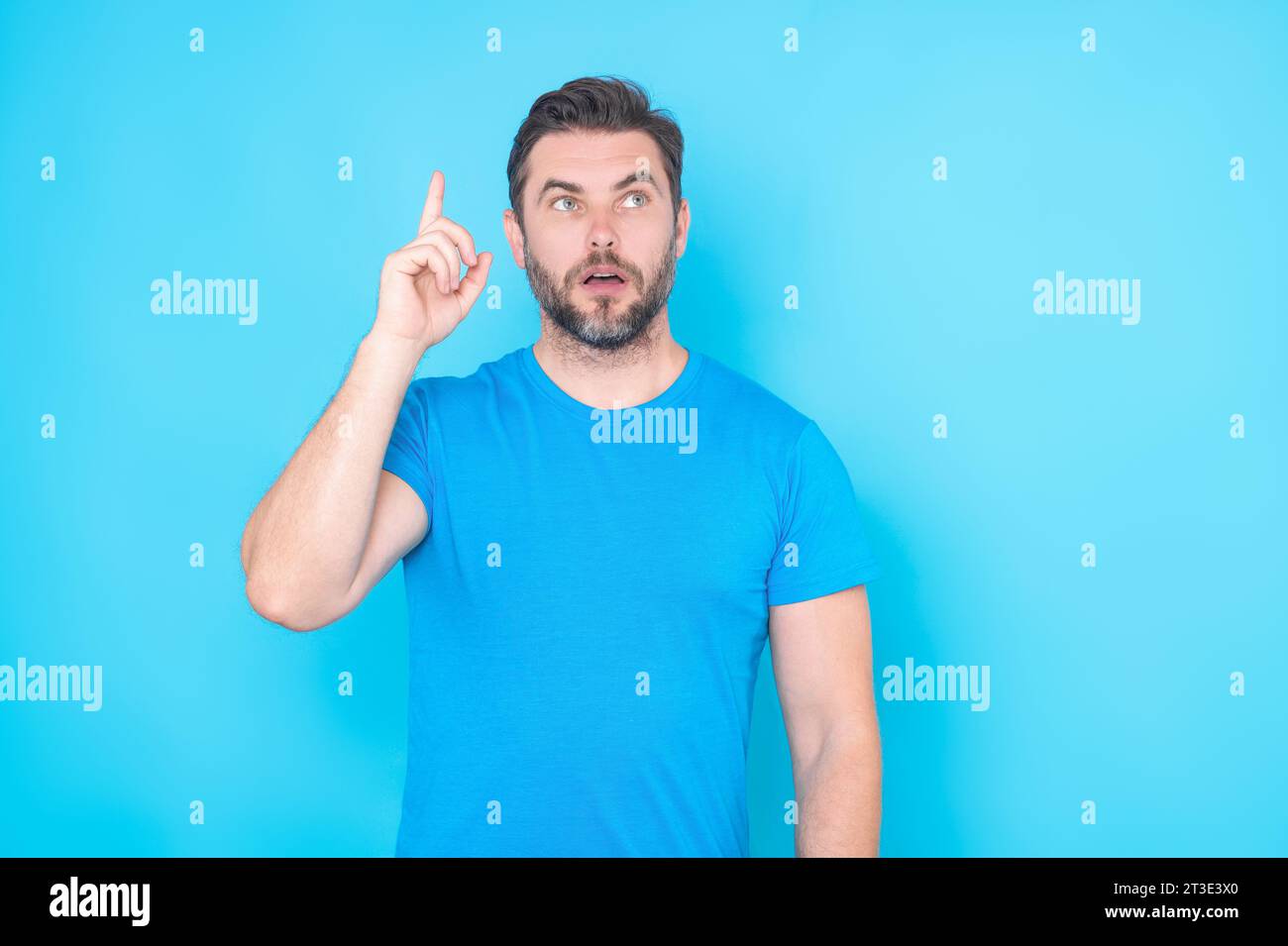 Thoughtful man point up thinking of idea, pointing up. Portrait of man ...