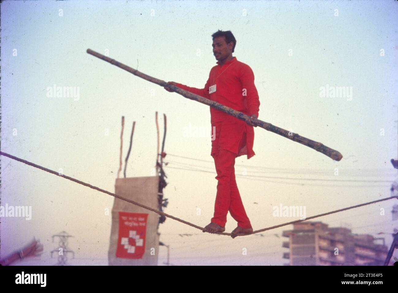 Man Walking on a Rope Between Two Pillars, With a Bamboo in Hand ...
