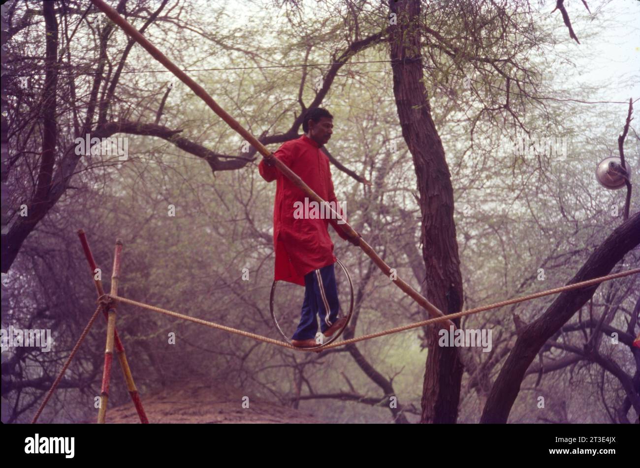 Man Walking on a Rope Between Two Pillars, With a Bamboo in Hand ...