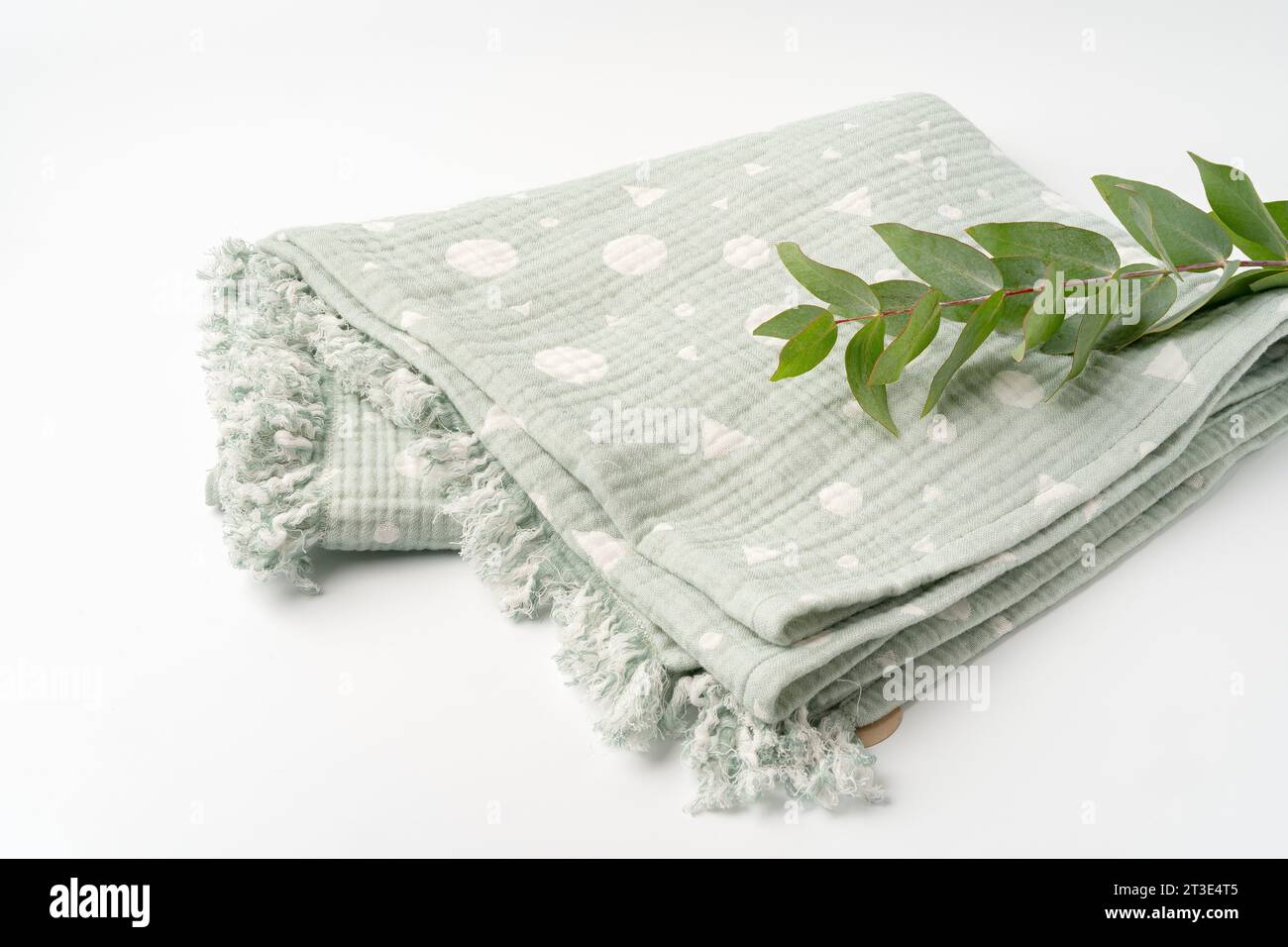 Green muslin blanket for kids on white background Stock Photo - Alamy