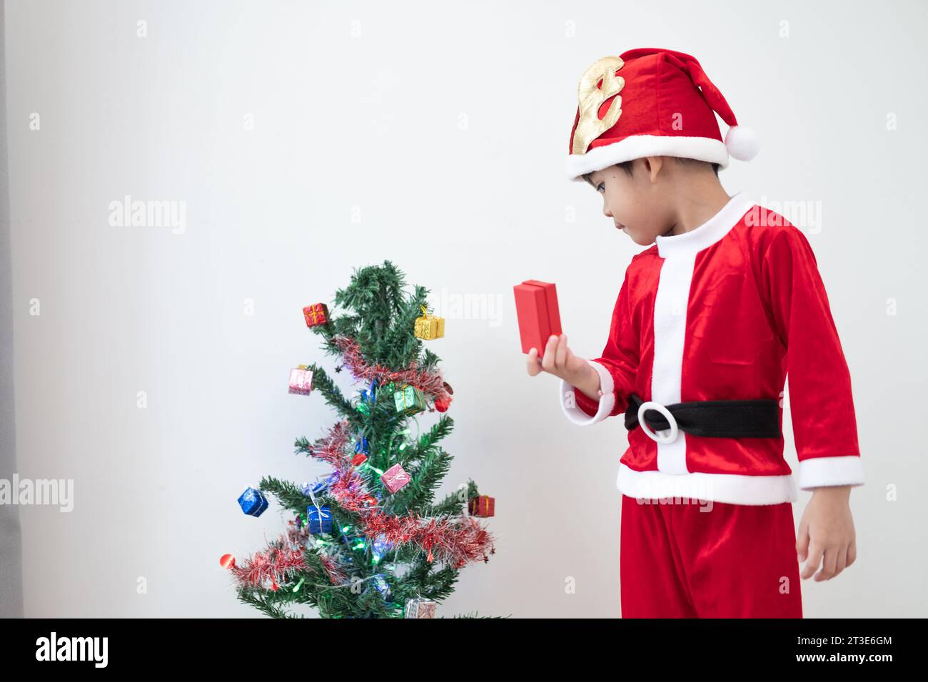 Asian boy wearing Santa costume Standing and playing near A fun ...