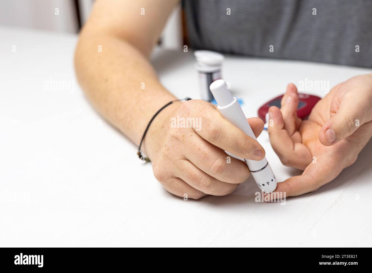 Male hands use an adjustable lancing device. Horizontally Stock Photo ...