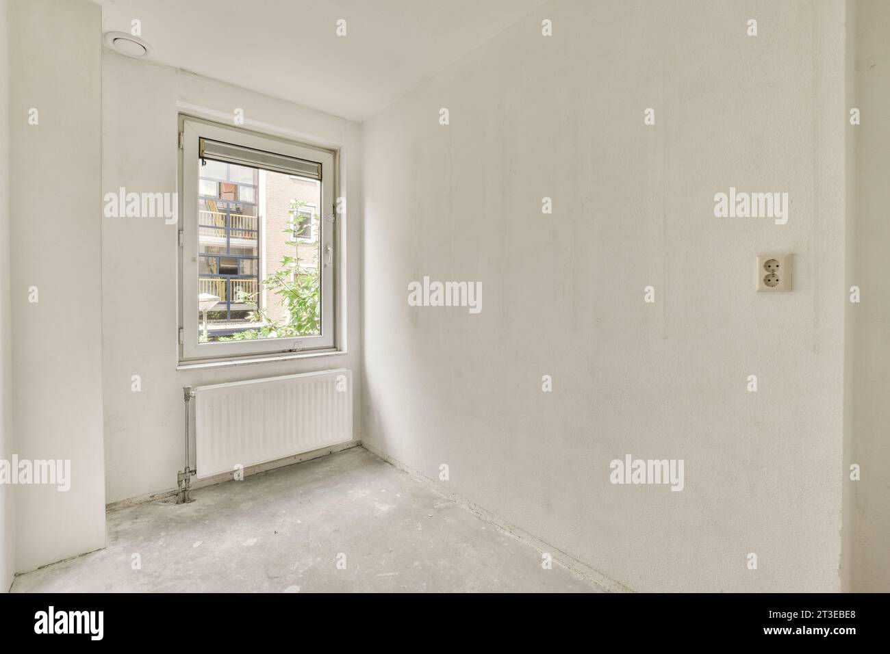 an empty room with white walls and no one person standing in the corner ...