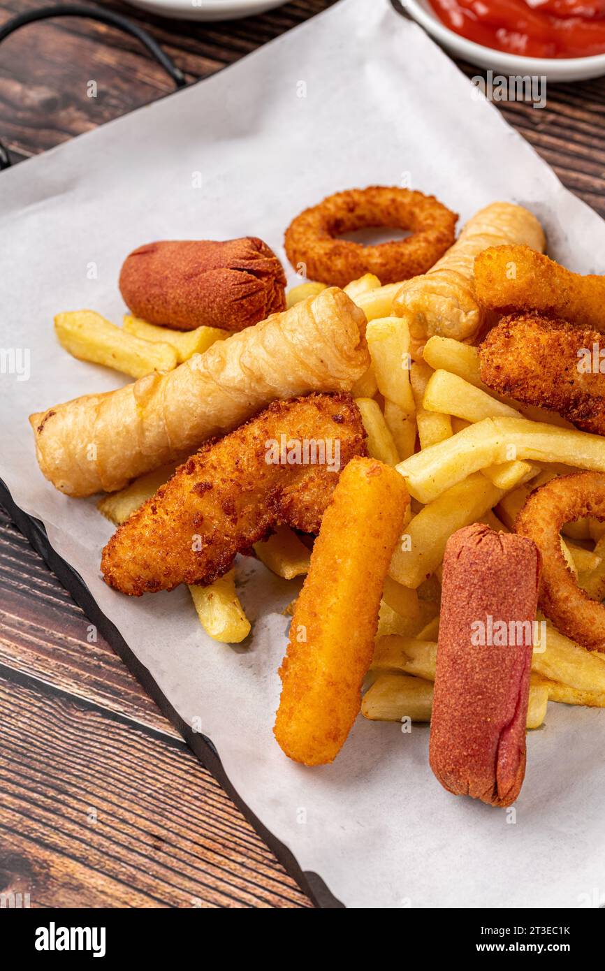 Snack plate with french fries, crispy chicken, cheese sticks, sausage ...