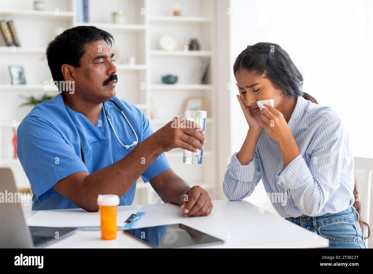 Indian doctor man comforting upset female patient crying during ...