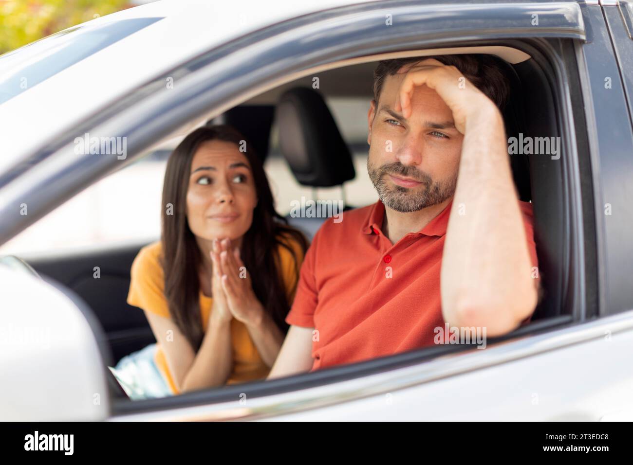 Pretty young woman begging for something her grumpy man driver Stock ...