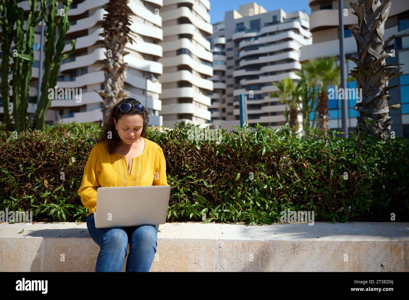 Confident purposeful multi-ethnic female student studying remotely ...