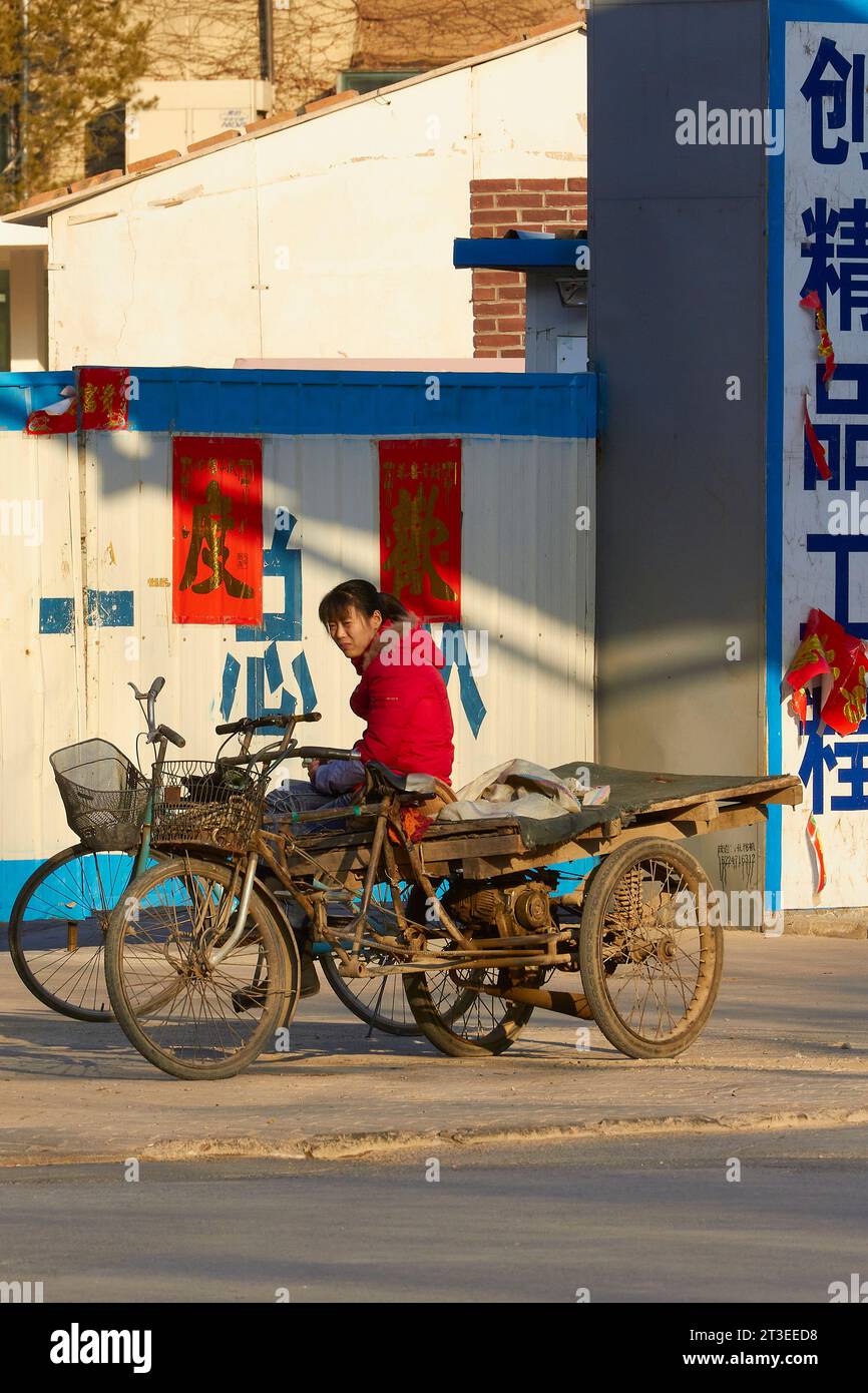 A Young Chinese Woman Sits On A Decrepit Auto Rickshaw In The 798 Art ...