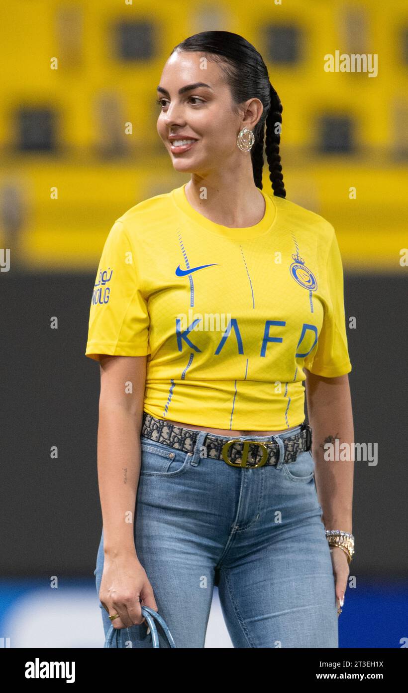 Georgina Rodriguez smiles on the pitch with a blue Birkin Alligator ...