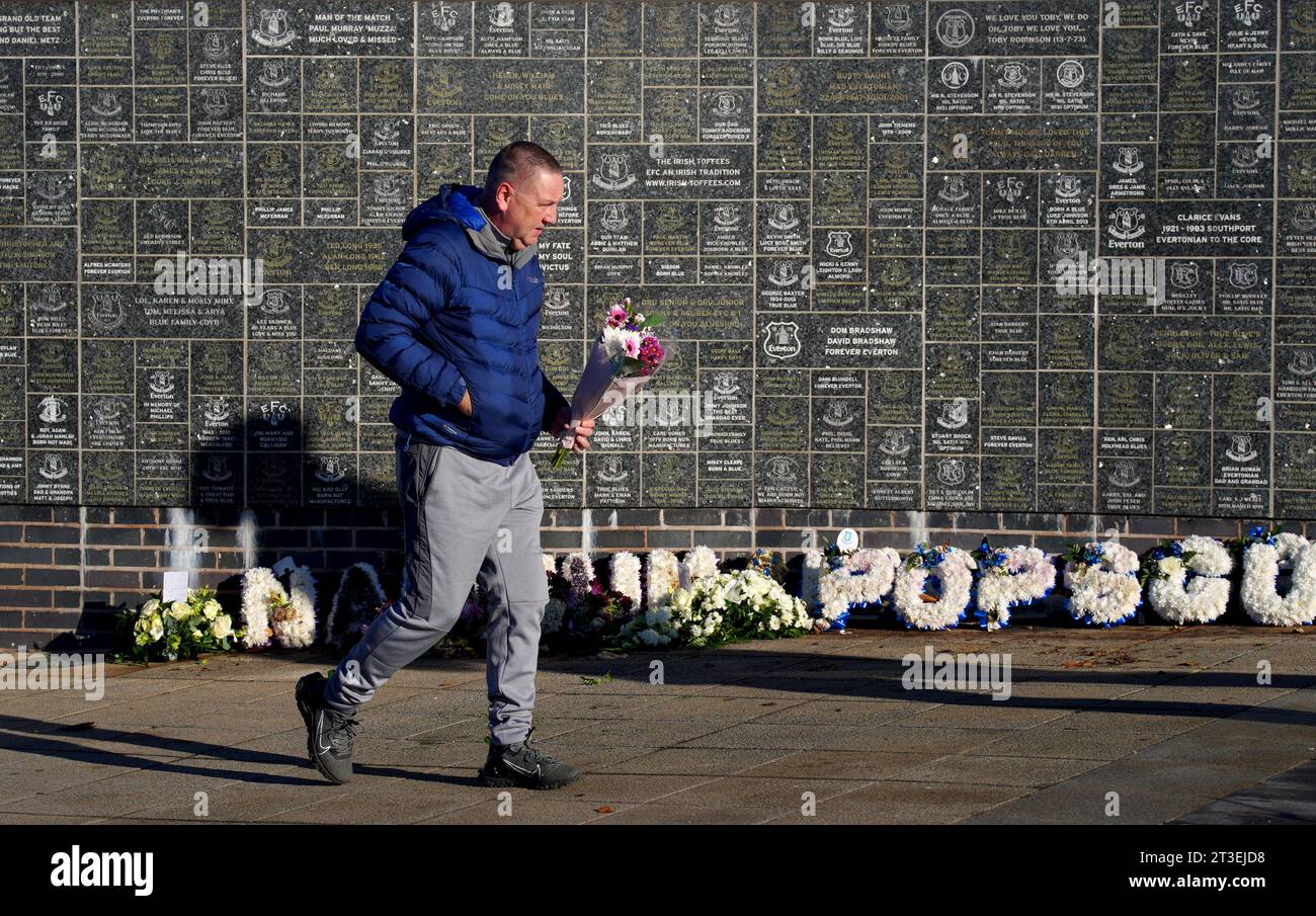 A fan leaves flowers outside Goodison Park in Liverpool in tribute to ...