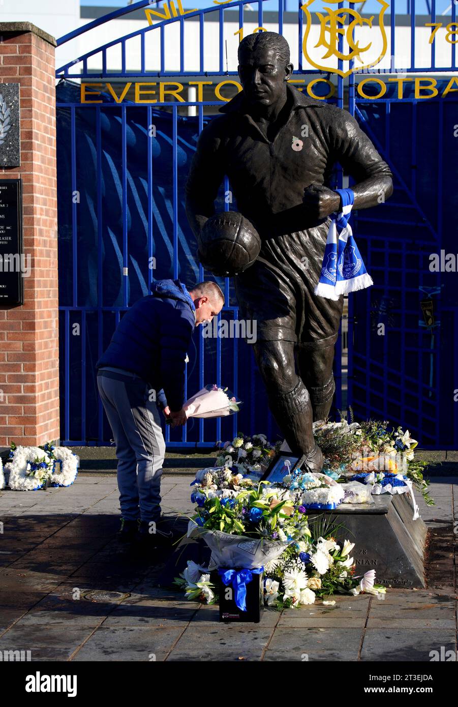 A fan leaves flowers by the Dixie Dean statue outside Goodison Park in ...