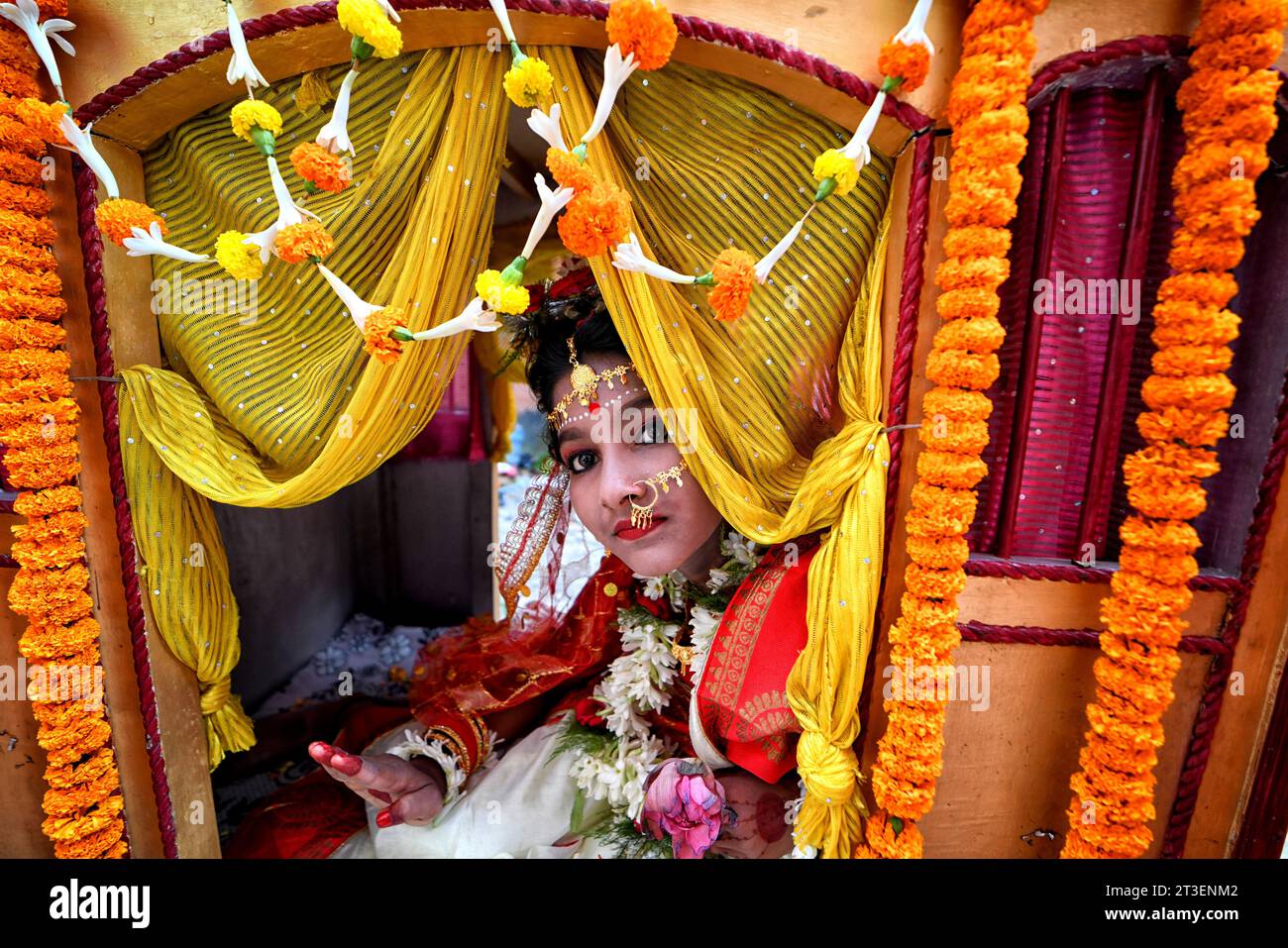 Little girl (Dipwantita Adhikary ) looks out from a Palki (palanquin) as she moves towards a ...