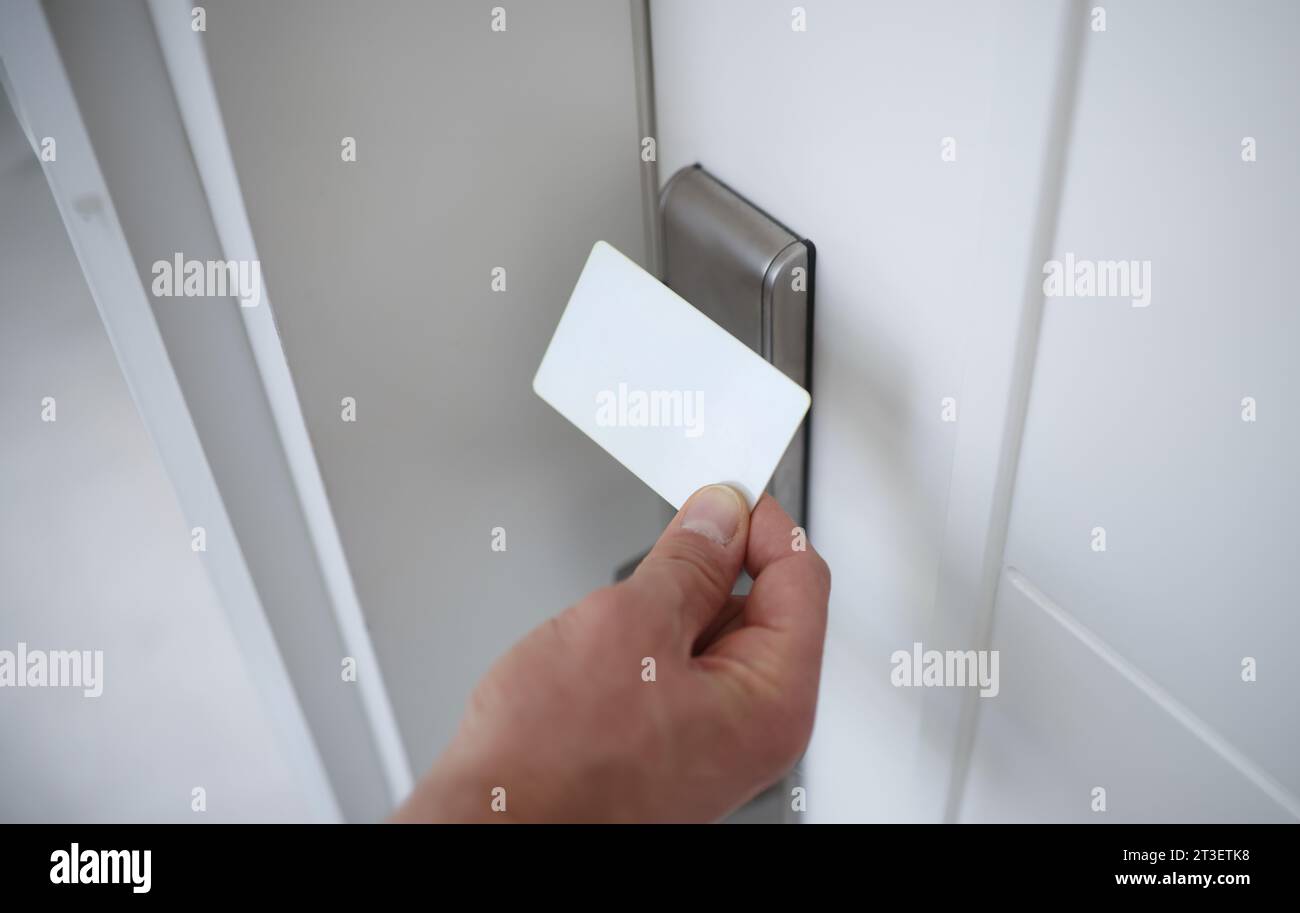 Male hand putting key card to lock on door closeup Stock Photo - Alamy