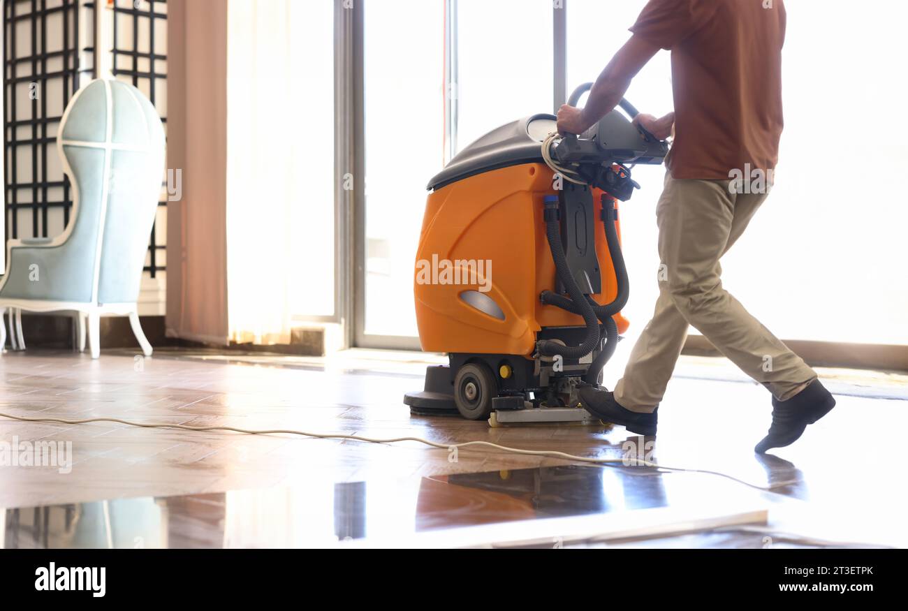 Cleaner washing floor in hotel using special machine closeup Stock ...