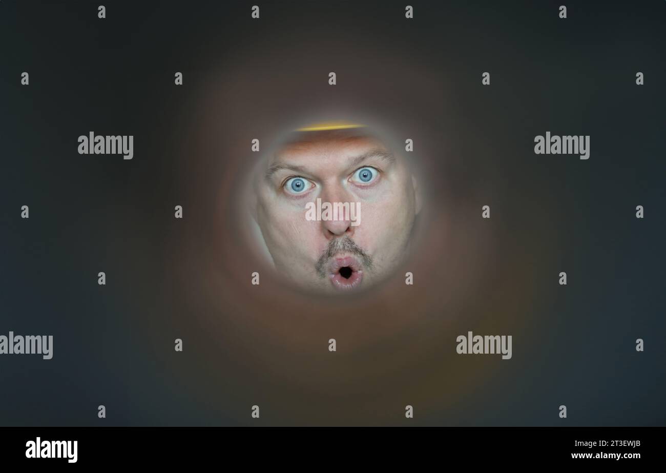 Man on his face uses facial expressions surprise Stock Photo - Alamy