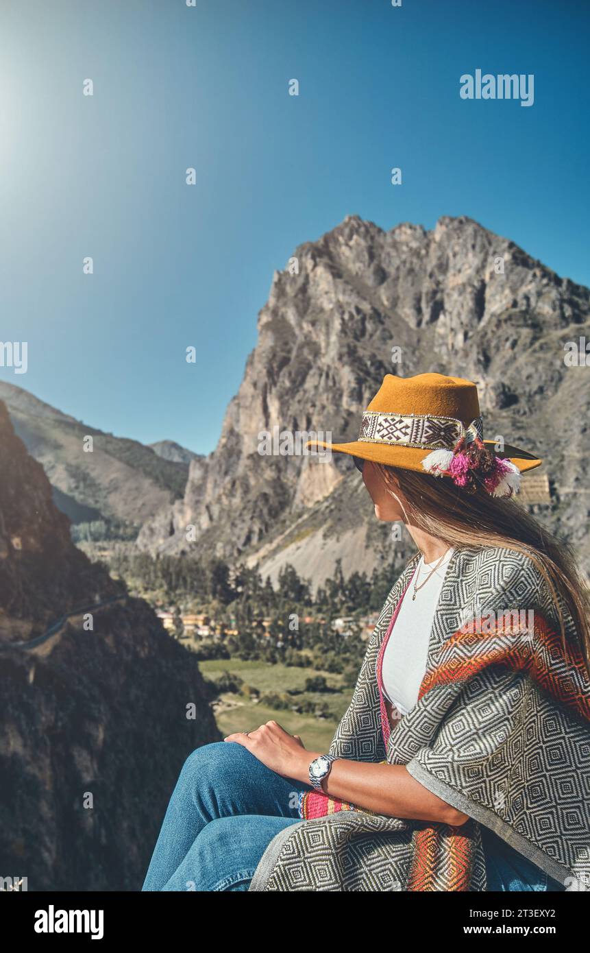 Traveler hipster girl in hat with backpack exploring ruins of ...