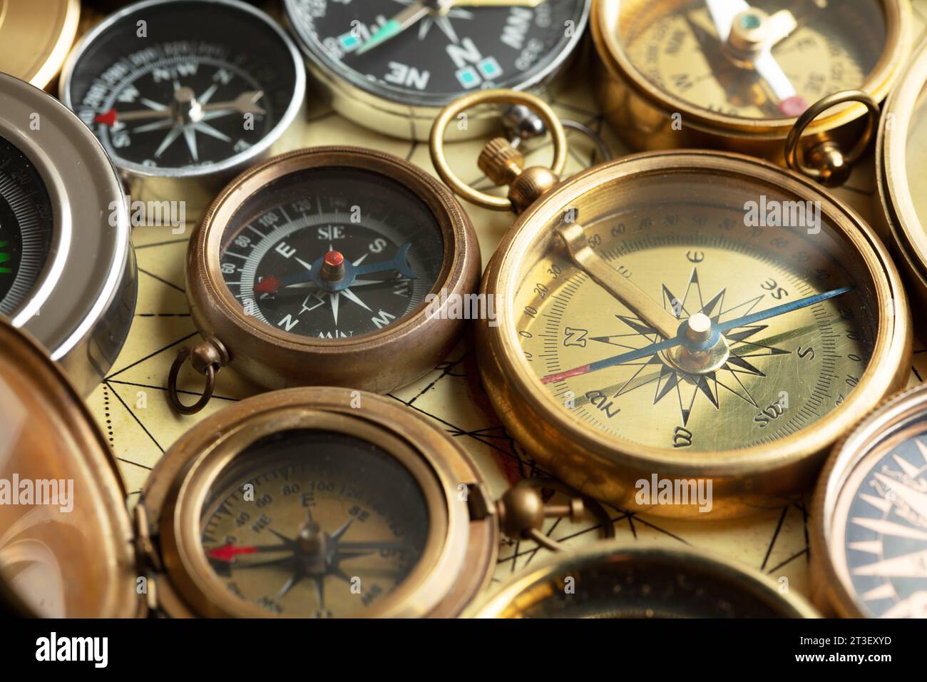 Many different compasses on an old map Stock Photo - Alamy