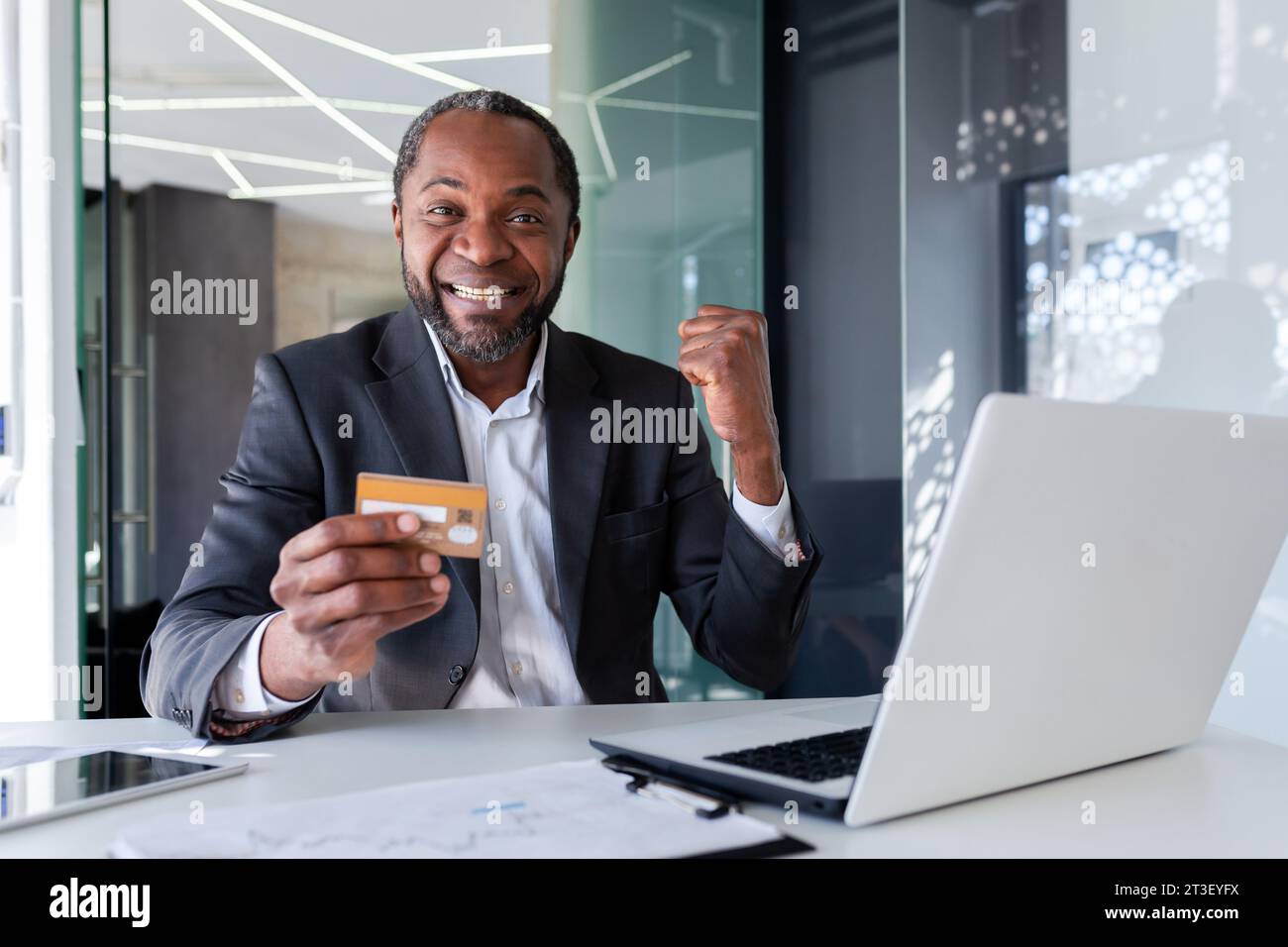 Portrait of happy African American winner inside office, man looking at ...