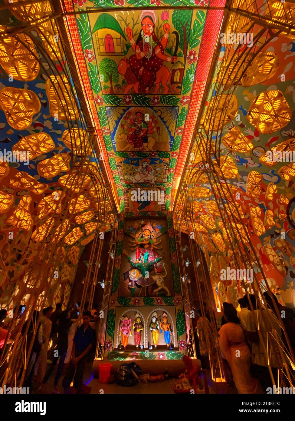 Visitors take photos of an idol of the Hindu Goddess Durga at a ...