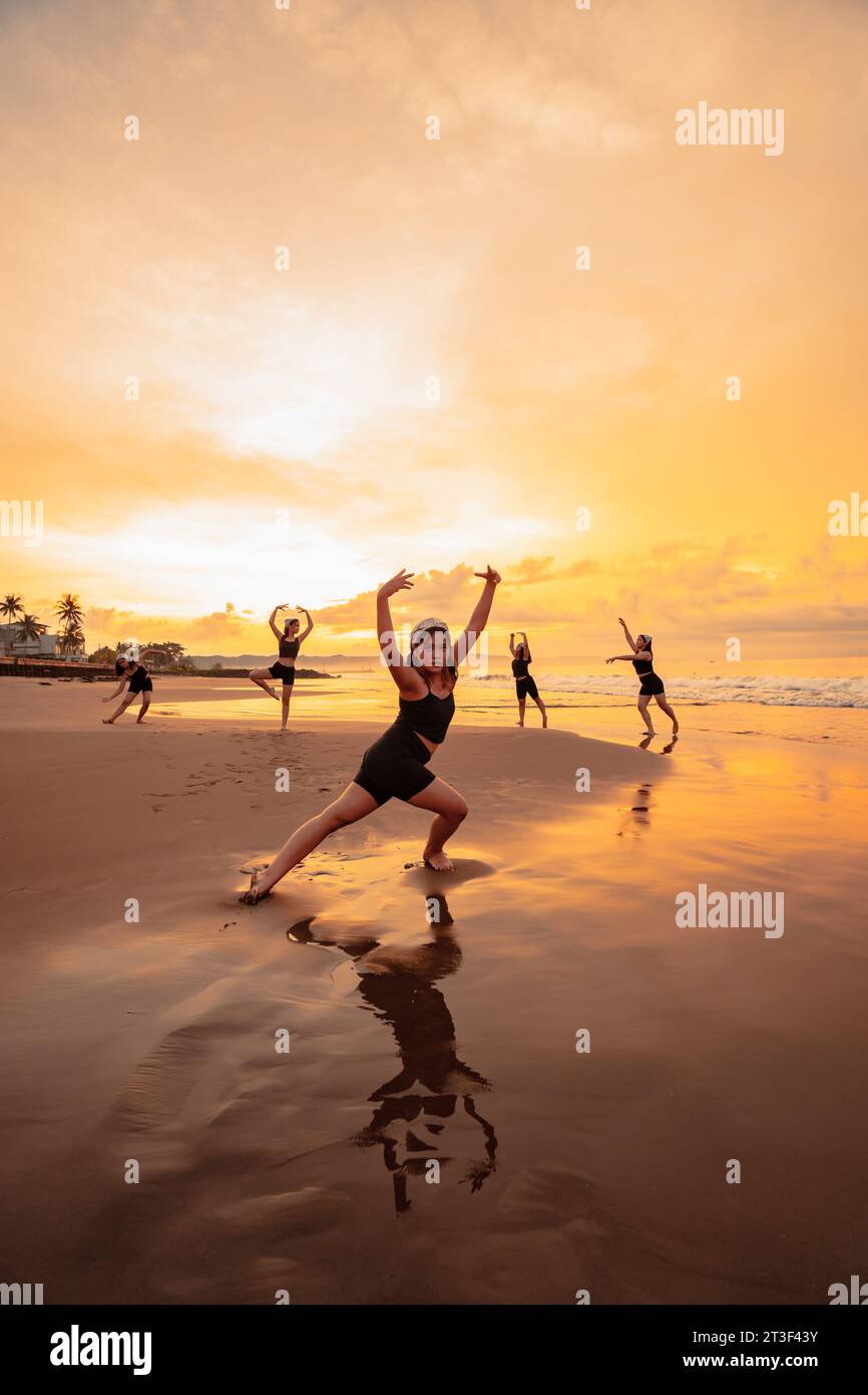 a group of Indonesian women doing ballet movement exercises together ...