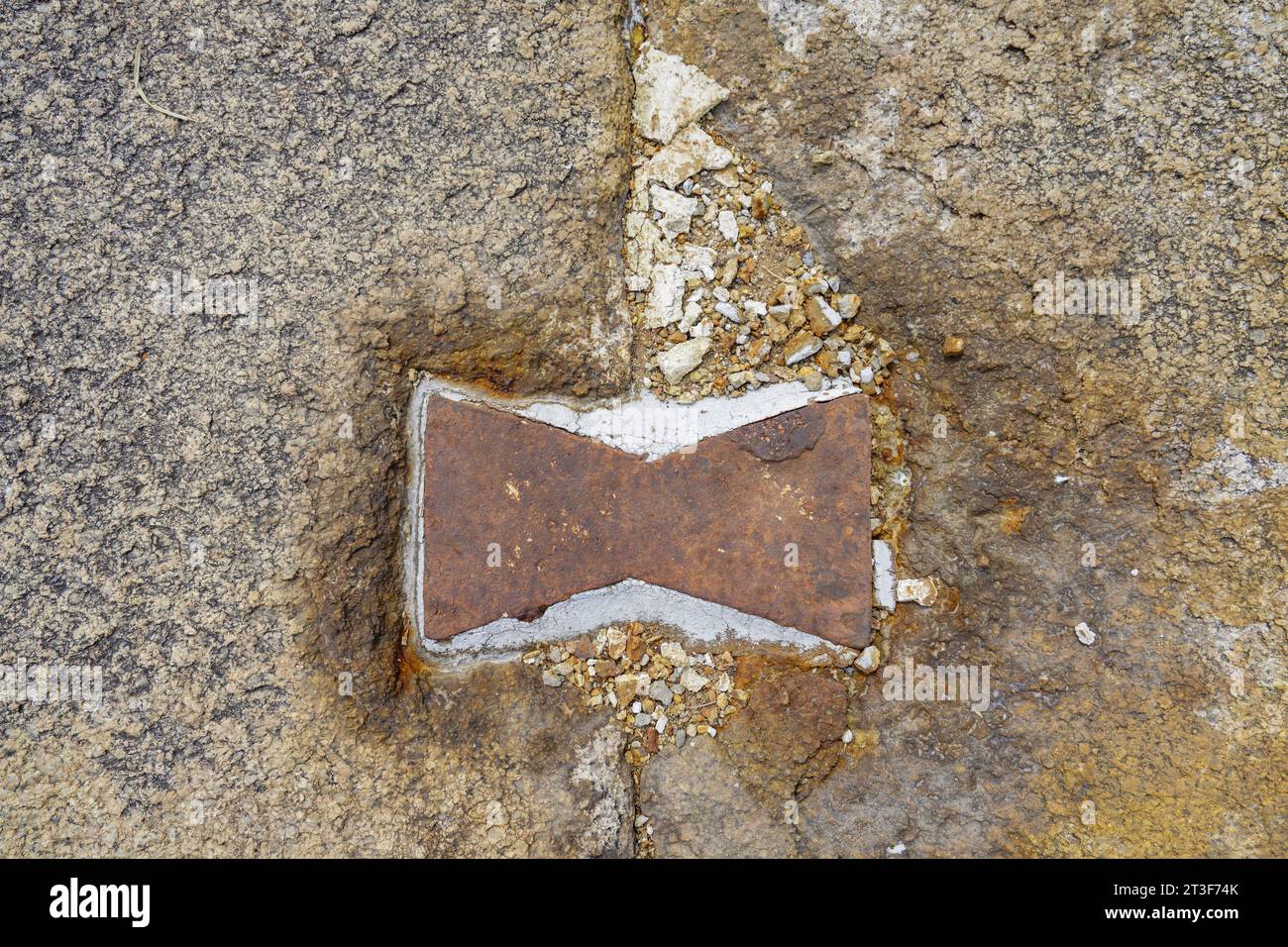 Metal components embedded in the middle of rocks Stock Photo - Alamy