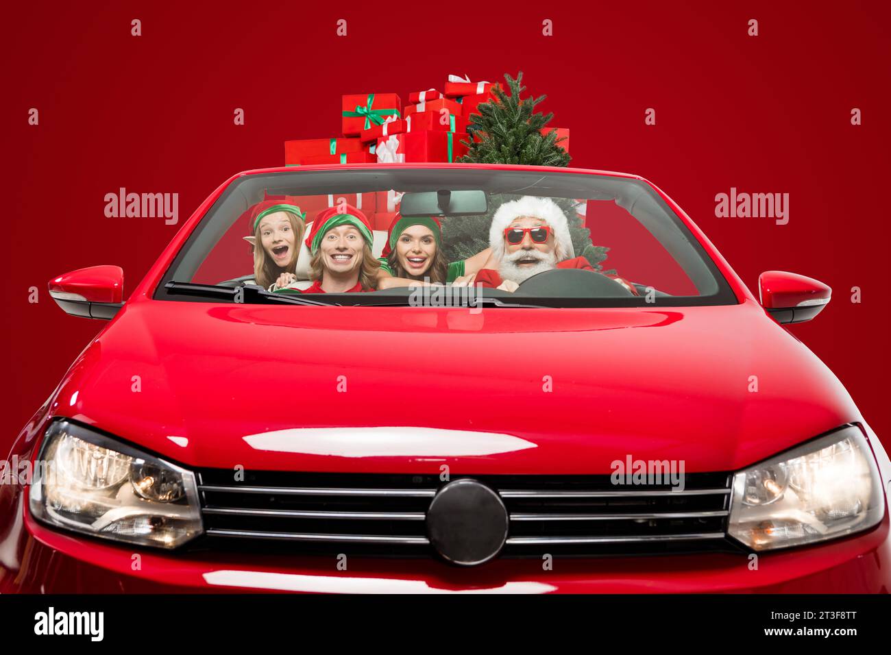 Portrait of attractive cheerful group elf riding car carrying boxes eve ...